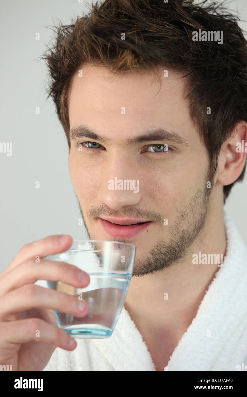 Young man with glass of water Stock Photo - Alamy