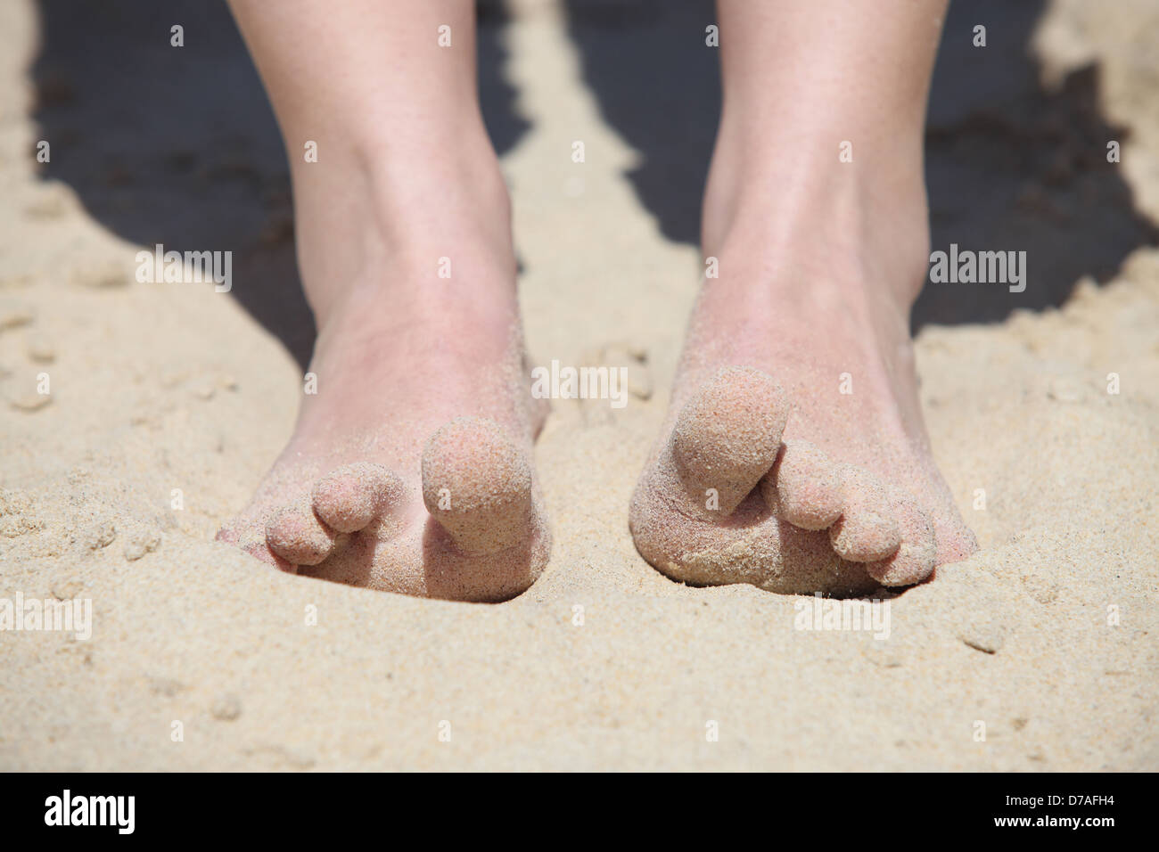Feet digging into the sand Stock Photo - Alamy