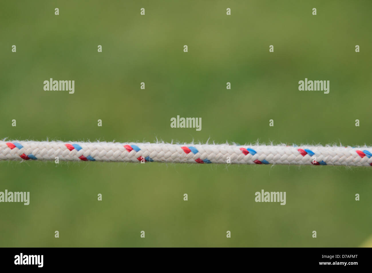 Rope tense over a meadow Stock Photo - Alamy