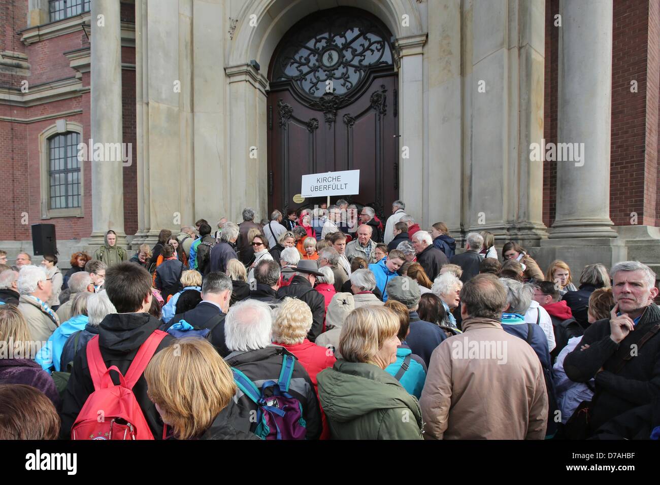 A church congress helper holds a sign reading 'Church overcrowded' up ...