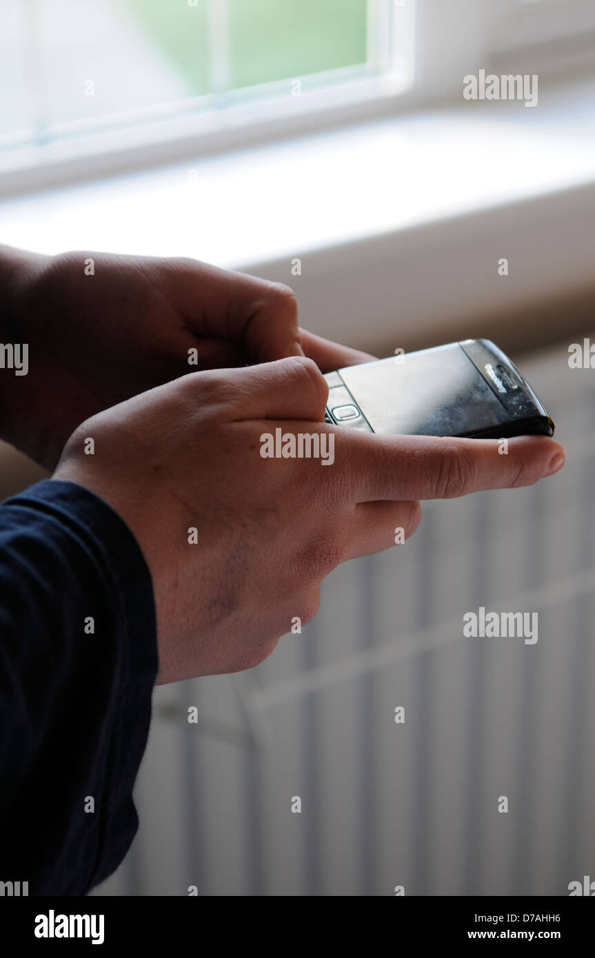 Teenage Boy Using A Mobile Phone Stock Photo - Alamy