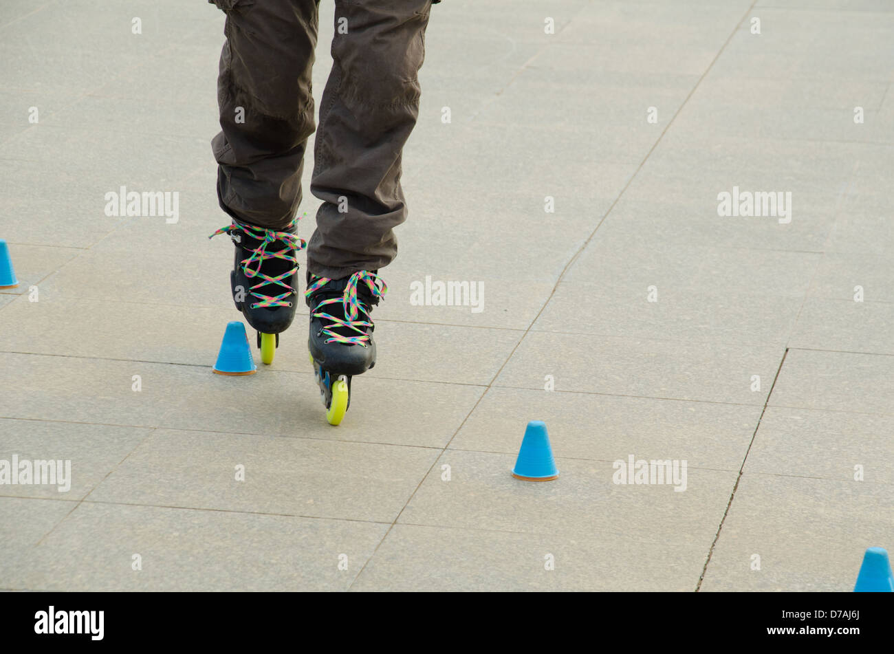 Roller skater practicing slalom along a line of cones Stock Photo - Alamy