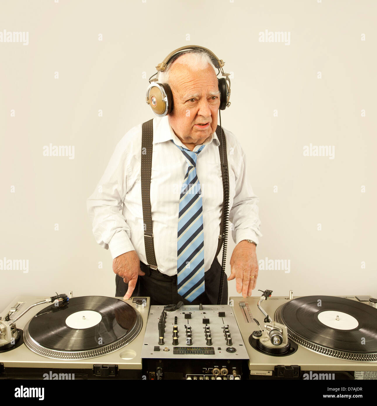 a very funky elderly grandpa dj mixing records Stock Photo - Alamy