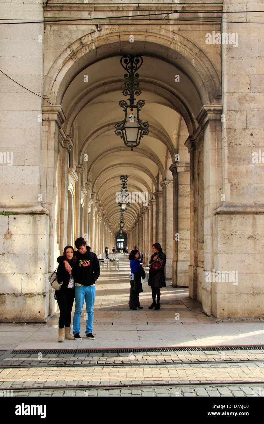 Young couple by a covered arched walkway, Commercial Square, Praca do ...
