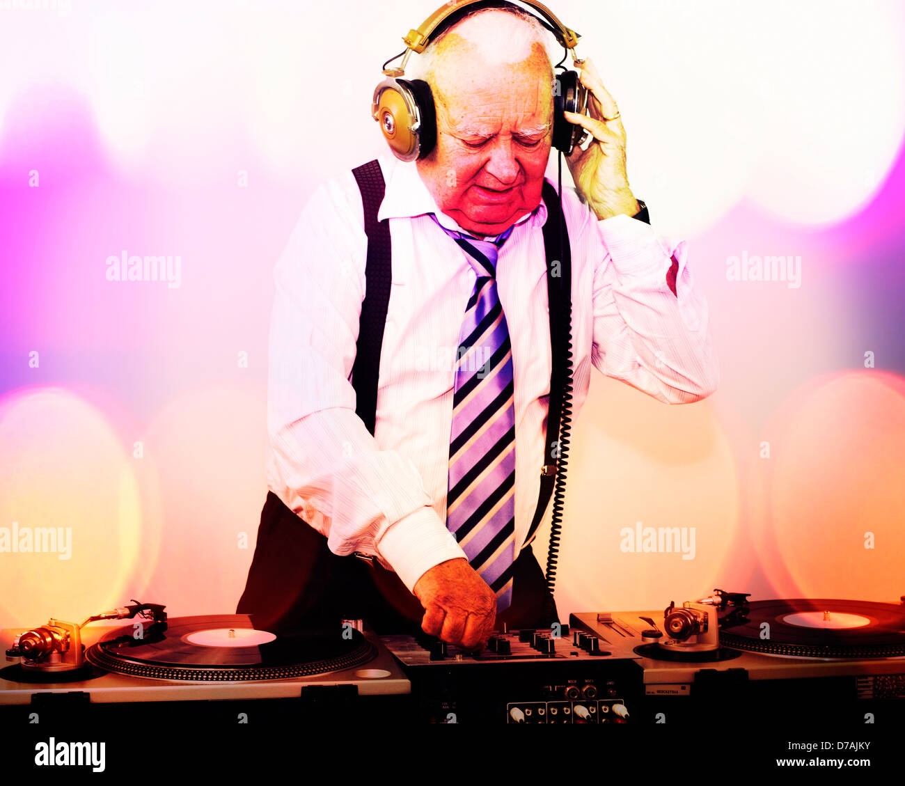 a very funky elderly grandpa dj mixing records Stock Photo - Alamy