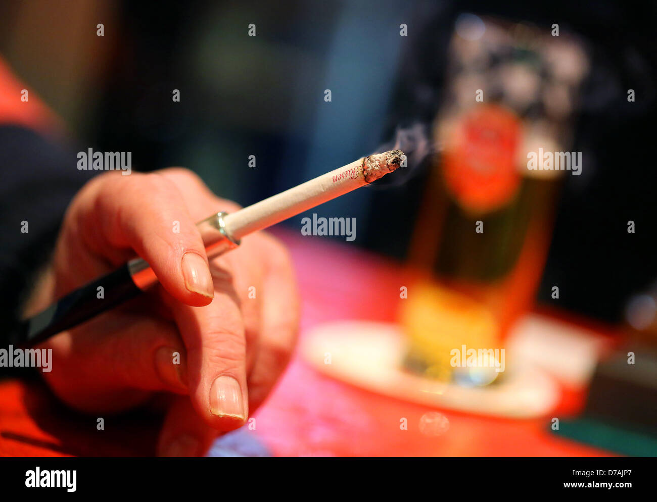 A man smokes a cigarette in a bar in Cologne, Germany, 30 April 2013 ...