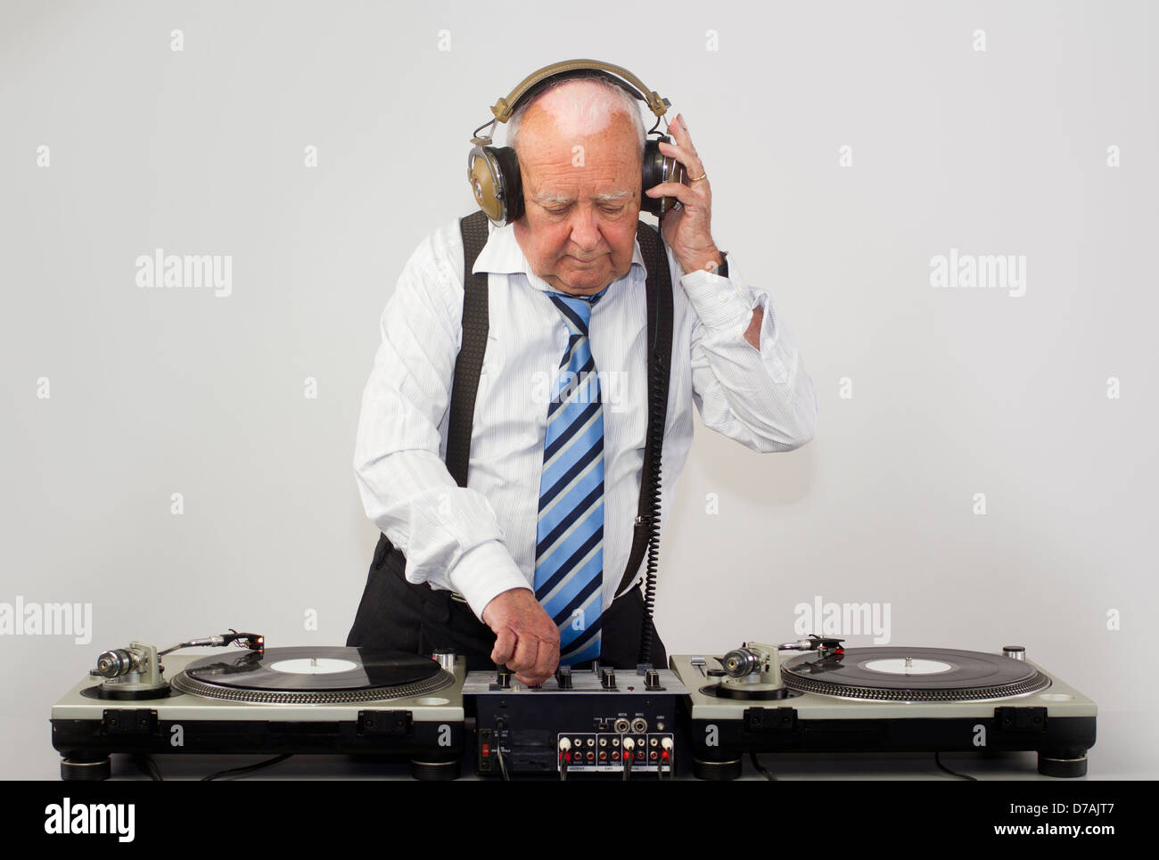 a very funky elderly grandpa dj mixing records Stock Photo - Alamy
