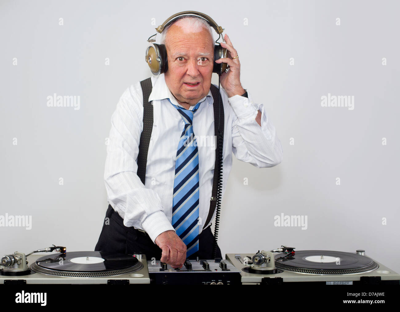 a very funky elderly grandpa dj mixing records Stock Photo - Alamy