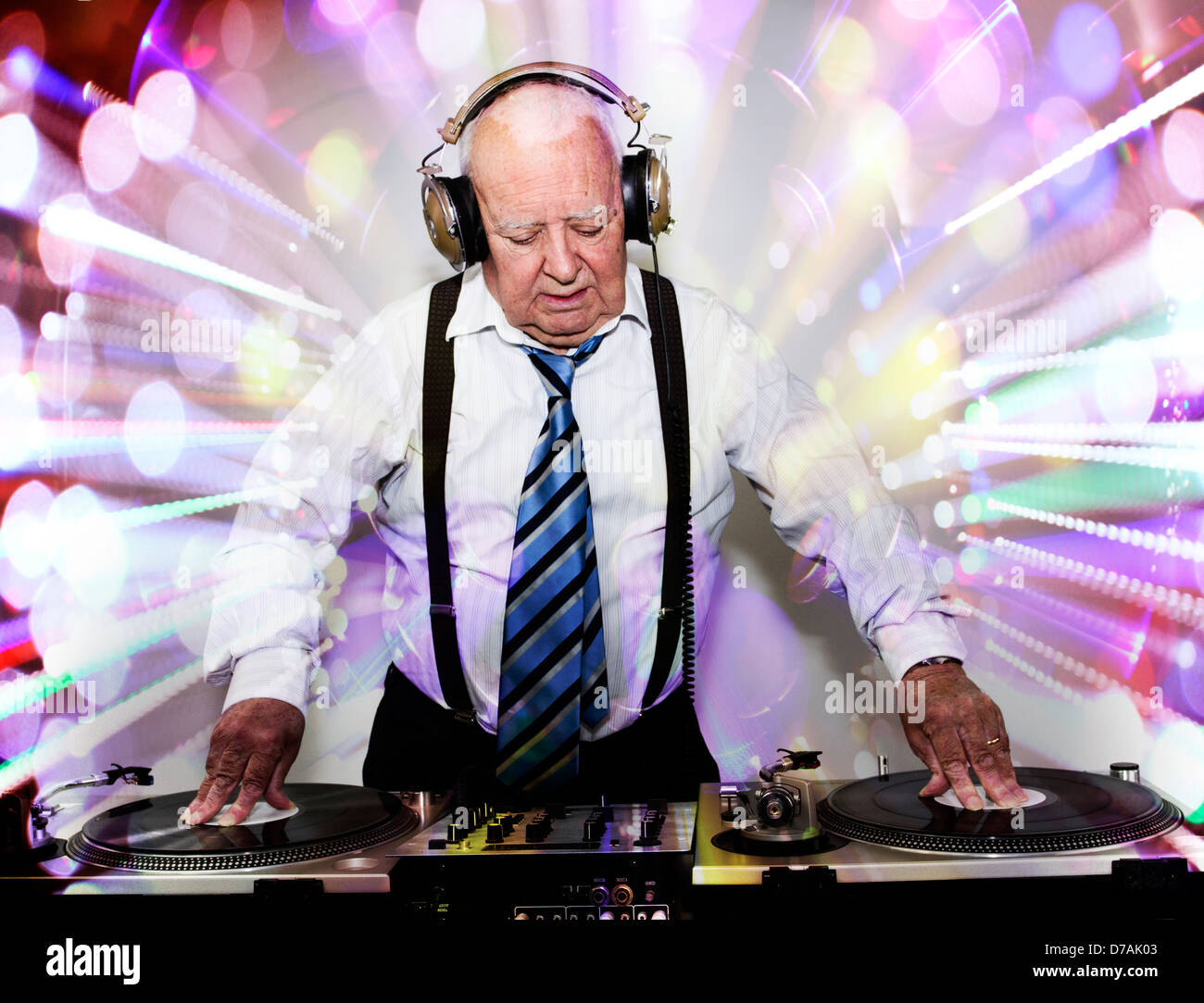 a very funky elderly grandpa dj mixing records Stock Photo - Alamy