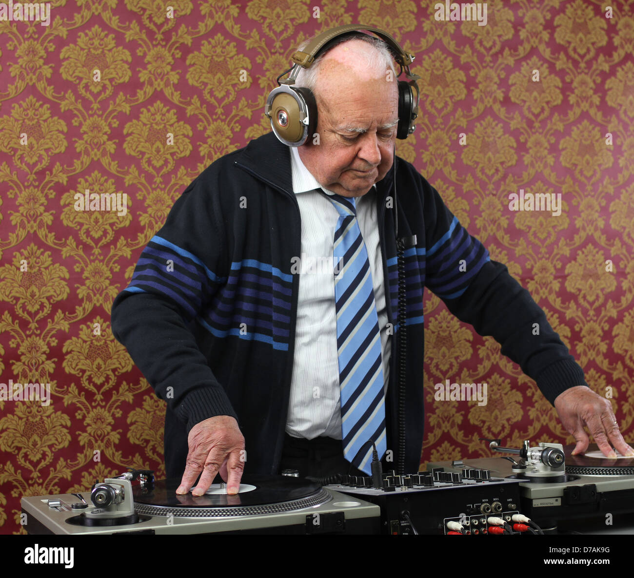 a very funky elderly grandpa dj mixing records Stock Photo - Alamy