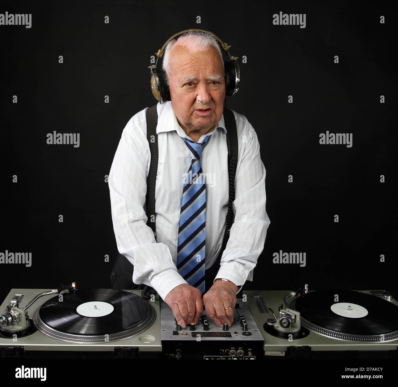 a very funky elderly grandpa dj mixing records Stock Photo - Alamy
