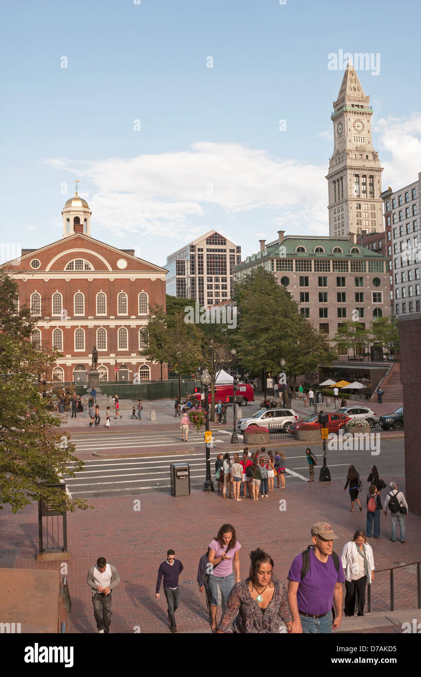 People walk through a historic part of Boston with Faneuil Hall in the ...