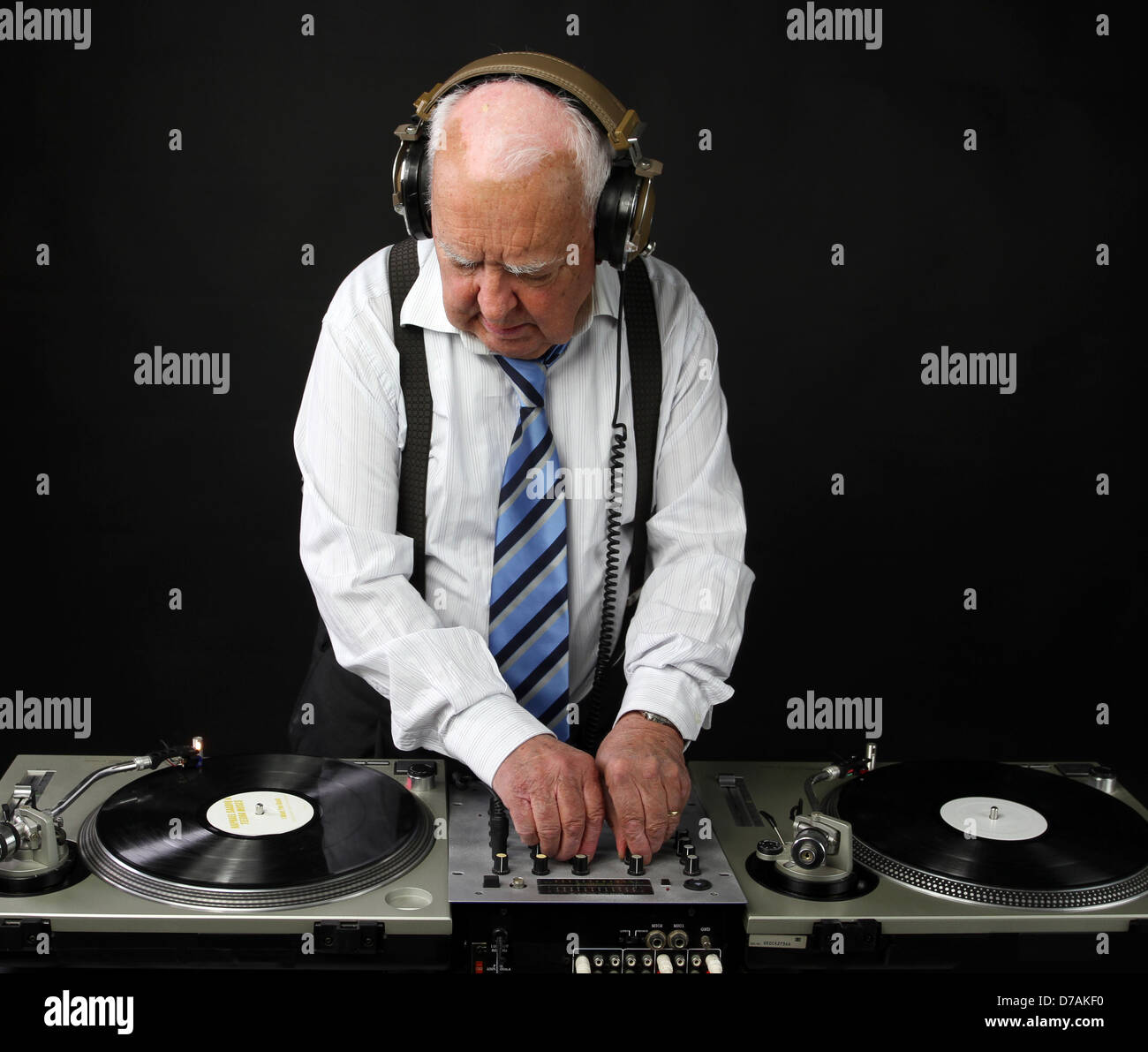 a very funky elderly grandpa dj mixing records Stock Photo - Alamy