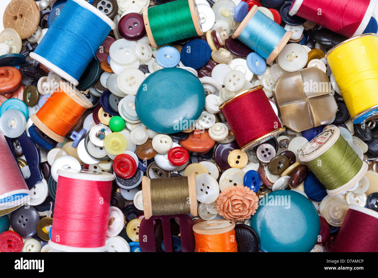 A collection of buttons and spools of sewing thread Stock Photo - Alamy
