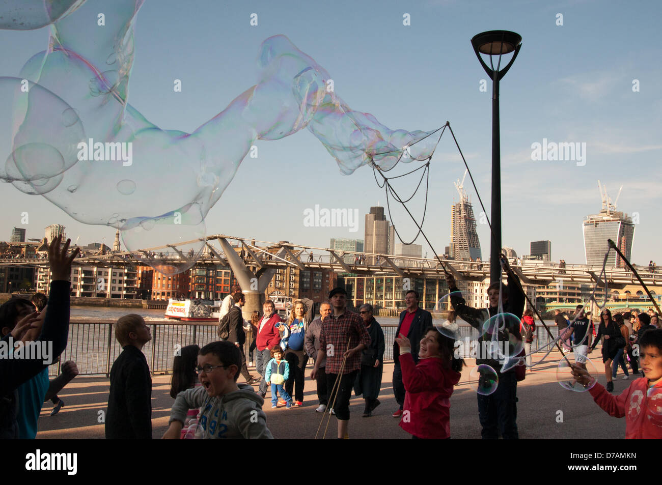 London, England UK 2nd May 2013. Street entertainers blow giant bubbles ...