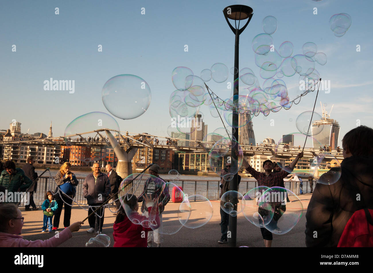 London, England UK 2nd May 2013. Street entertainers blow giant bubbles ...