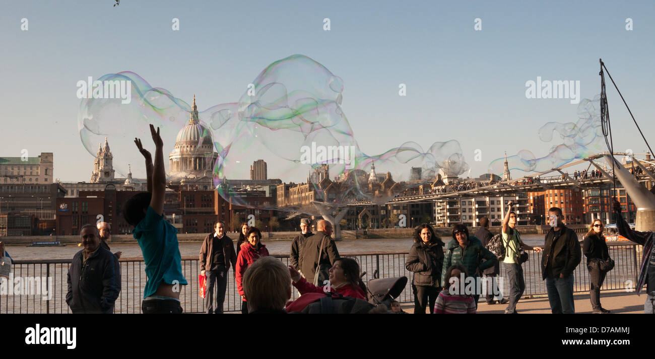 London, England UK 2nd May 2013. Street entertainers blow giant bubbles ...