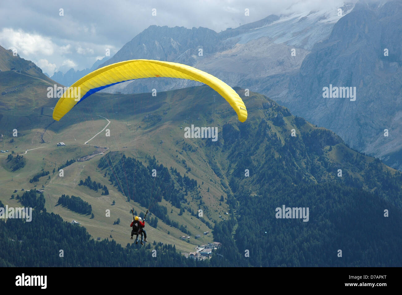 Shot of a tandem paraglider flying through the spectacular Dolomite ...