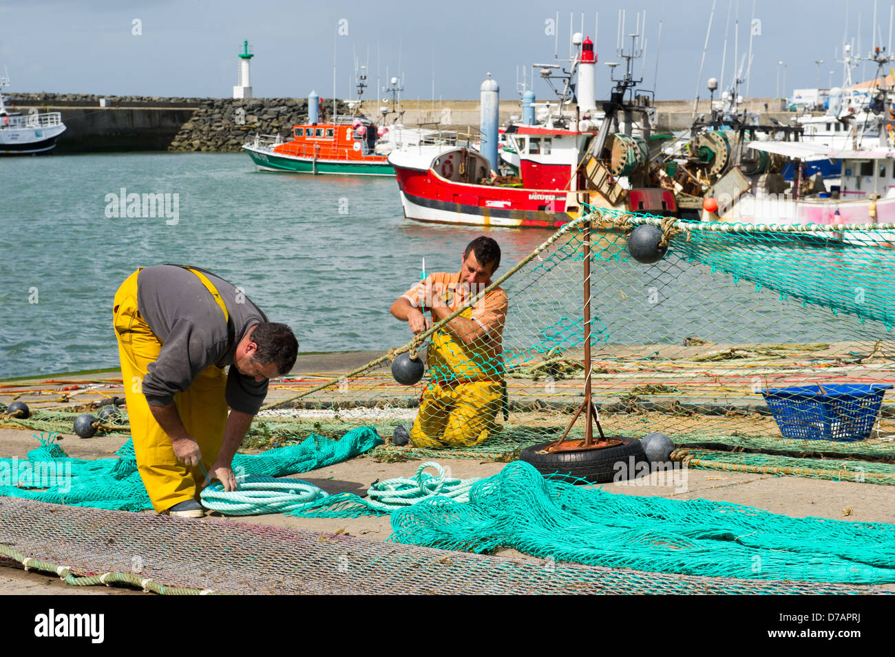 Working fishermen in French harbor Stock Photo - Alamy