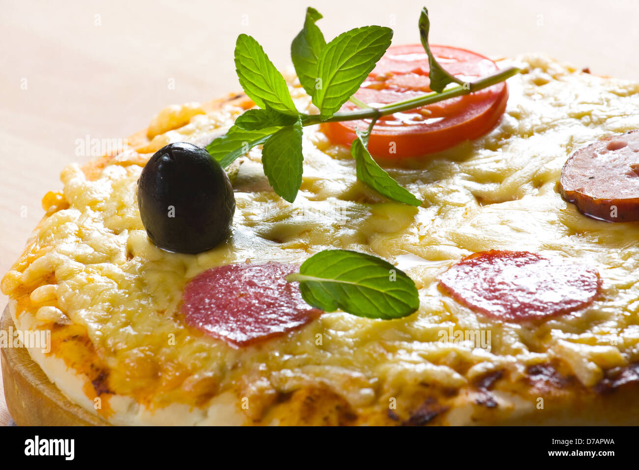 Round Italian pizza with salami, olives and cheese Stock Photo - Alamy