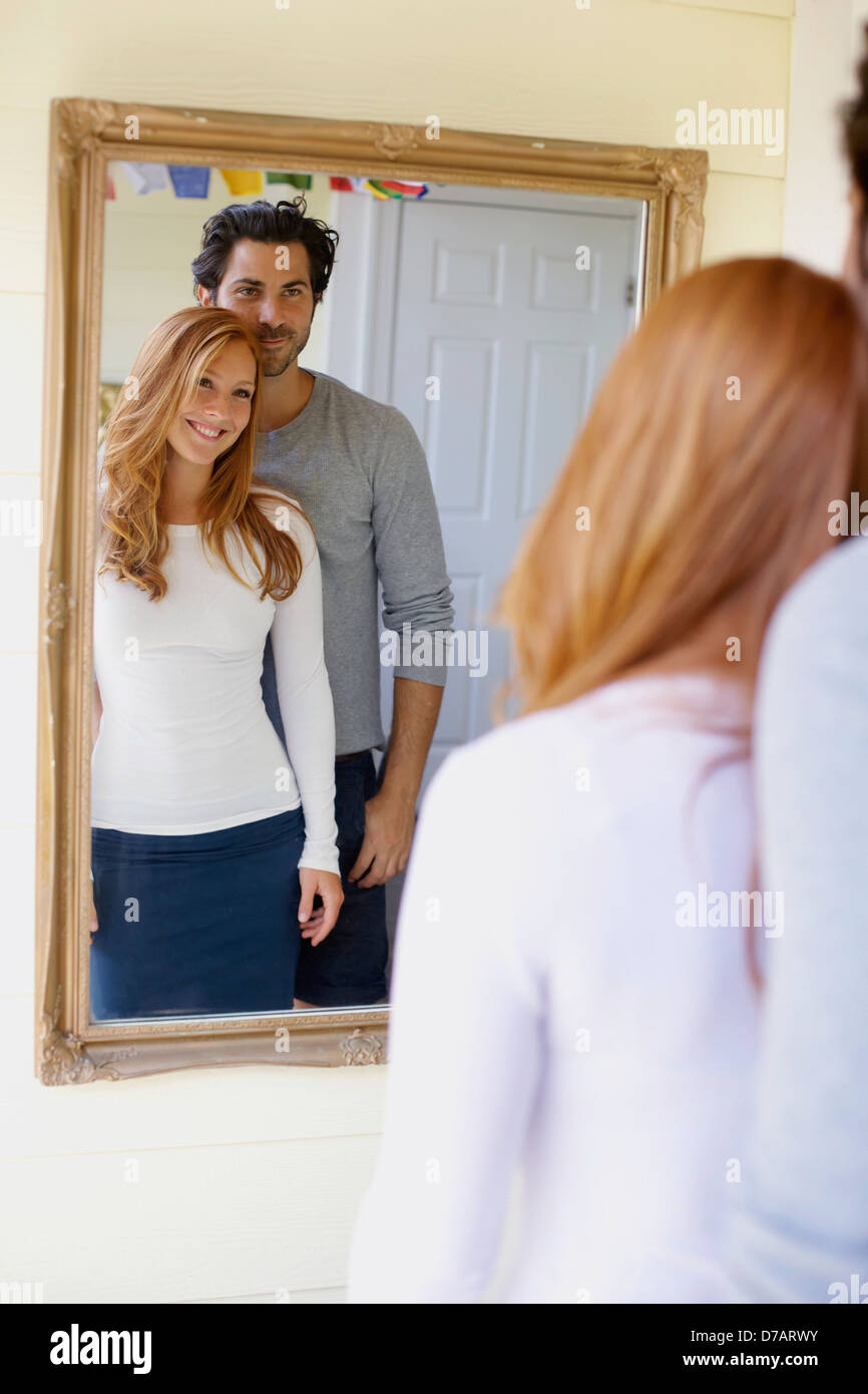 A Couple Looking At A Reflection Of Themselves In A Mirror;Wailua Kauai ...