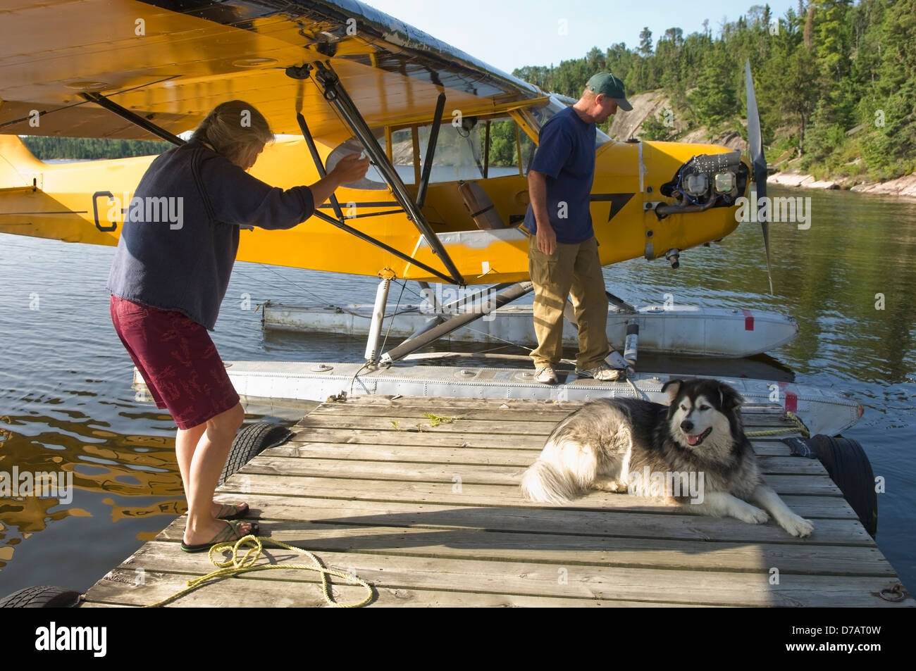 Middle Aged Couple Preparing Their Piper Cub Float Plane For Launch At ...
