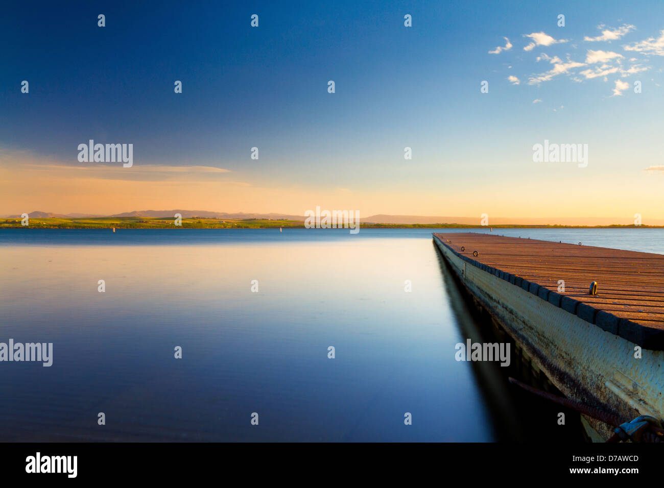 Sunset by dock near Deer Flat Upper Dam on shores of Lake Lowell ...