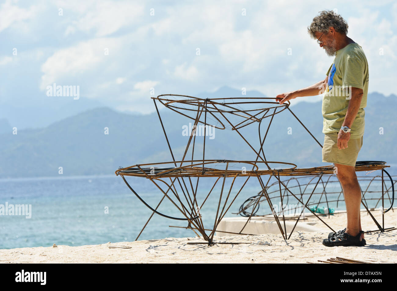 Scientist Thomas Goreau checking a newly built Biorock structure during ...