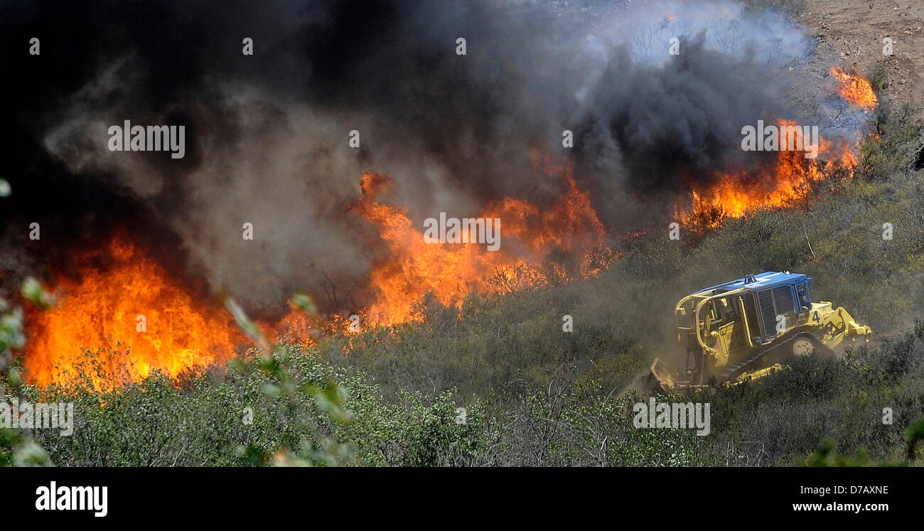 Camarillo, CA, USA. May 2, 2013. A fire dozer tries to stop a wall of ...