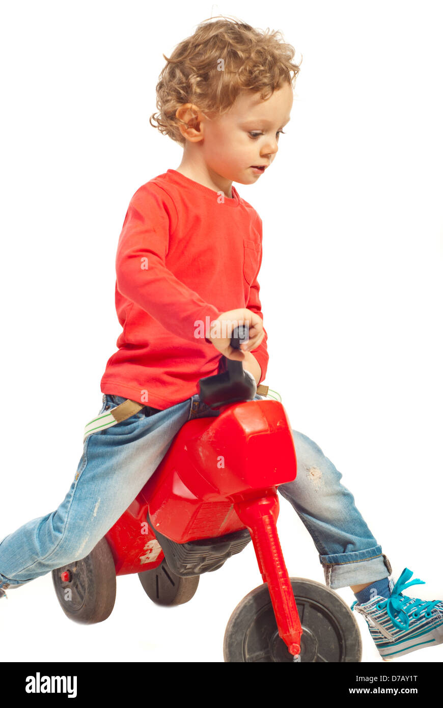 Playful toddler riding a bike isolated on white background Stock Photo ...