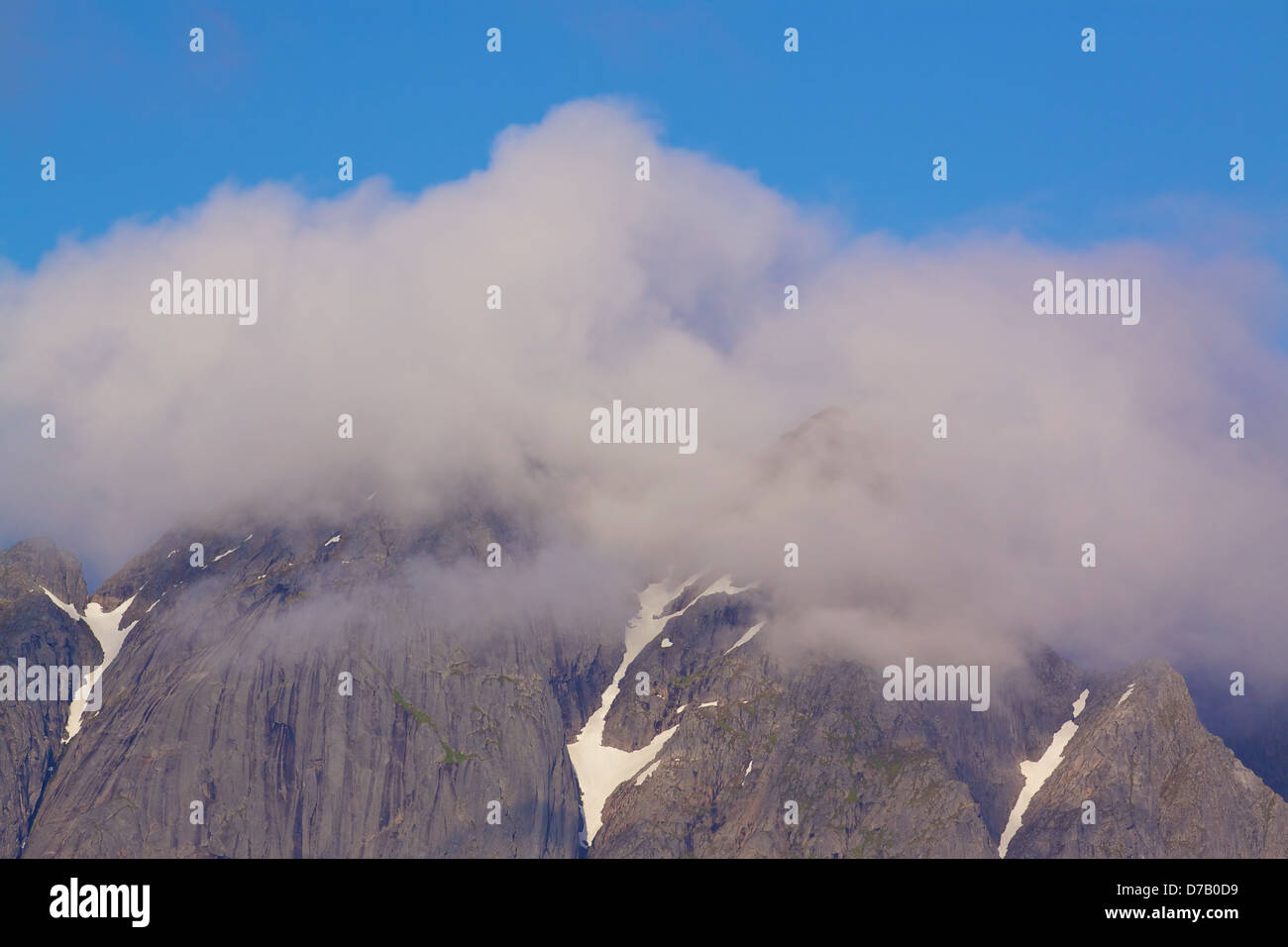 Scenic mountain peaks covered by clouds on Lofoten islands in Norway ...