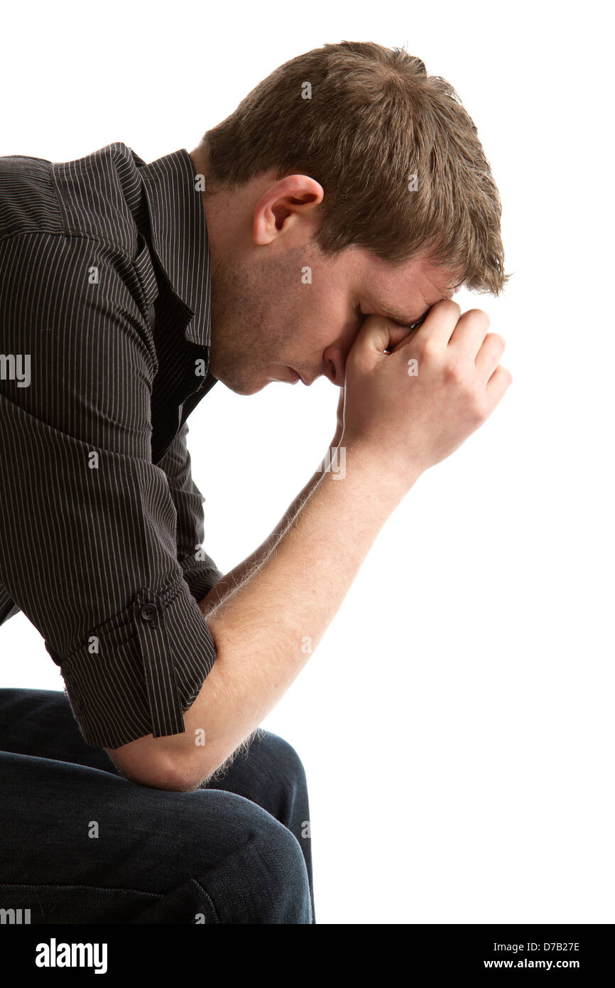profile of young male with head in hands in studio Stock Photo - Alamy