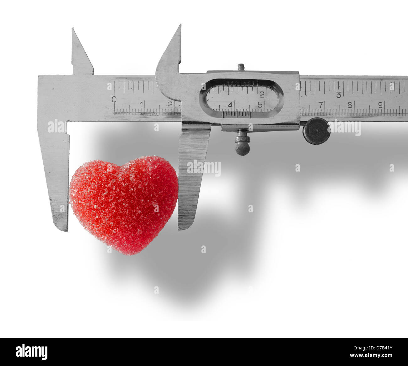 Heart measured with caliper. Isolted over white background Stock Photo ...
