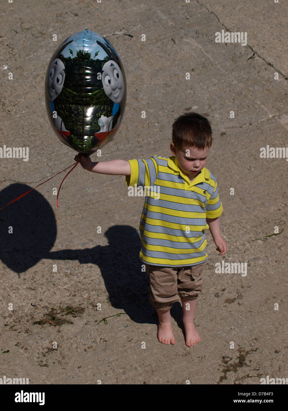 Child with balloon foil hi-res stock photography and images - Alamy