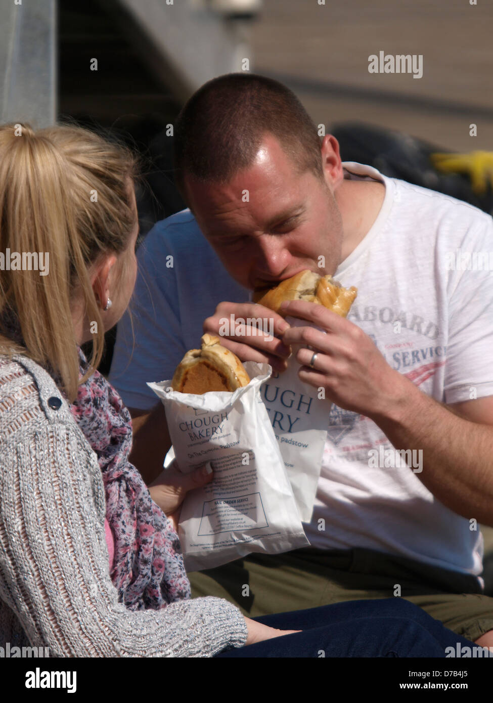 Couple eating Cornish Pasties, Padstow, Cornwall, UK 2013 Stock Photo ...