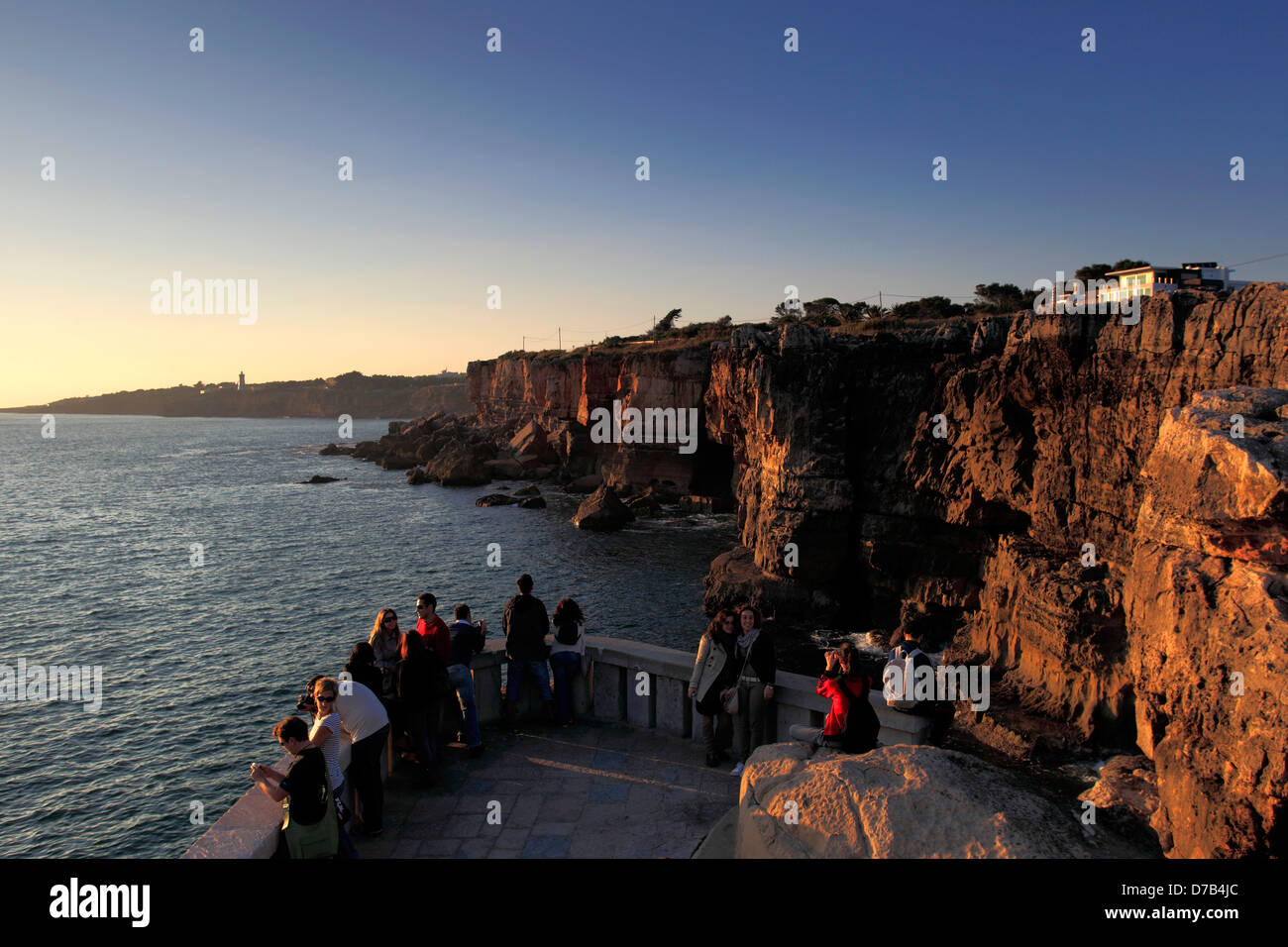 People watching the sunset over the Atlantic Ocean at Boca do Inferno ...