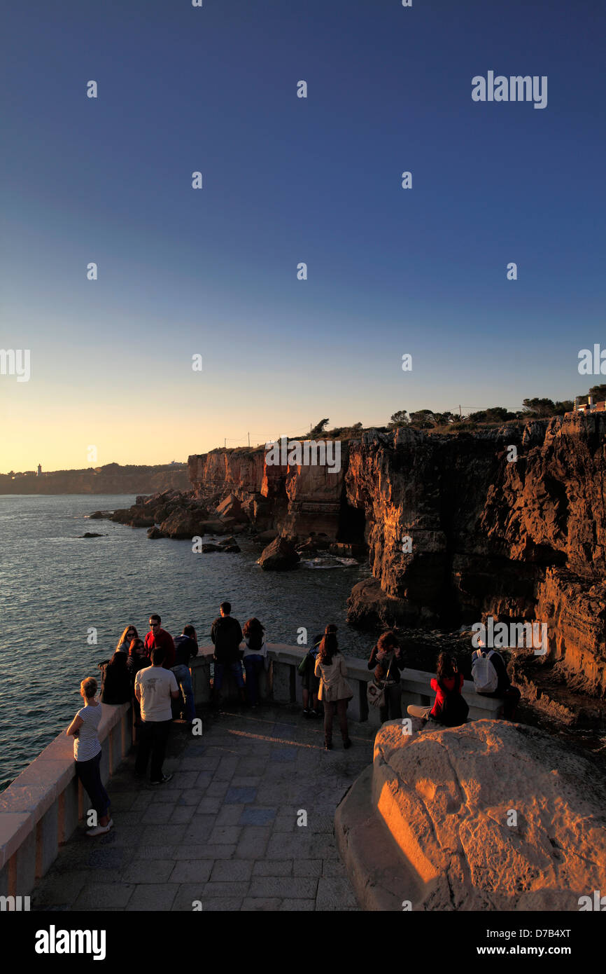 People watching the sunset over the Atlantic Ocean at Boca do Inferno ...