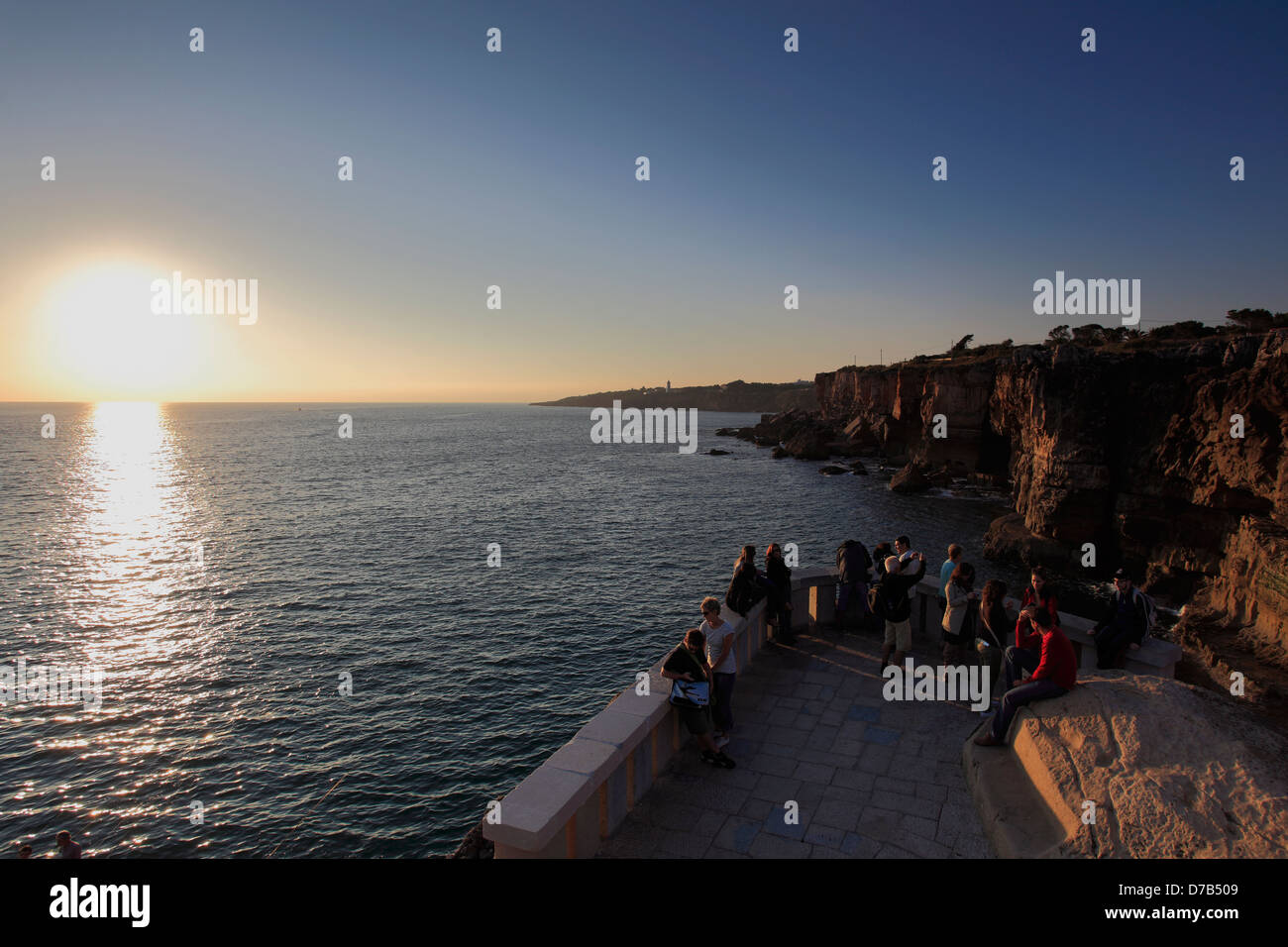 People watching the sunset over the Atlantic Ocean at Boca do Inferno ...