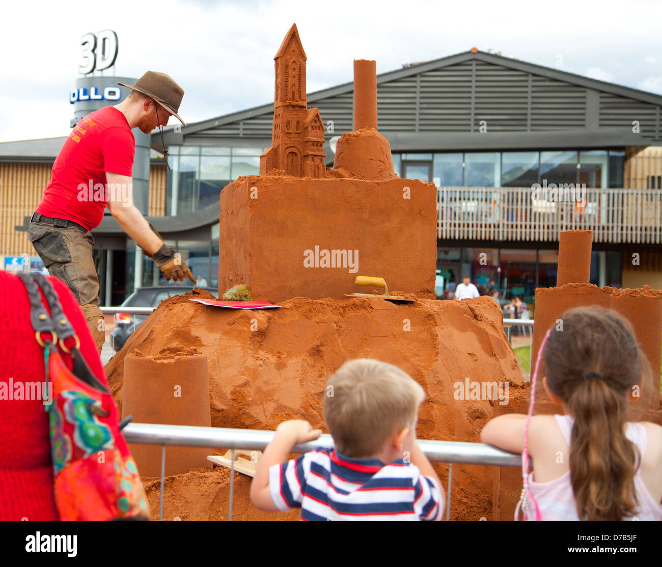 Sand artists Sand In Your Eye creating a sculpture of a castle on Rhyl ...