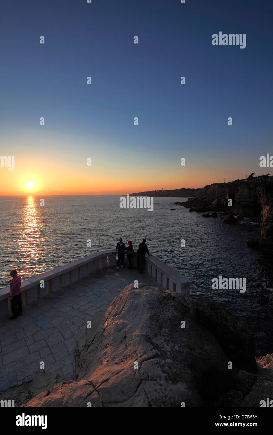 People watching the sunset over the Atlantic Ocean at Boca do Inferno ...