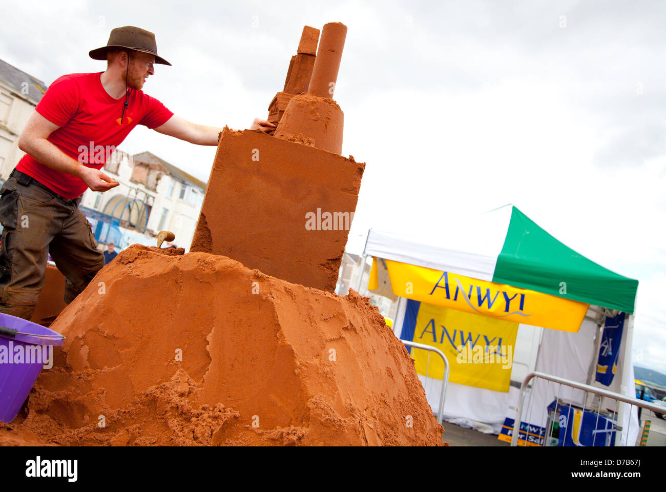Sand artists Sand In Your Eye creating a sculpture of a castle on Rhyl ...