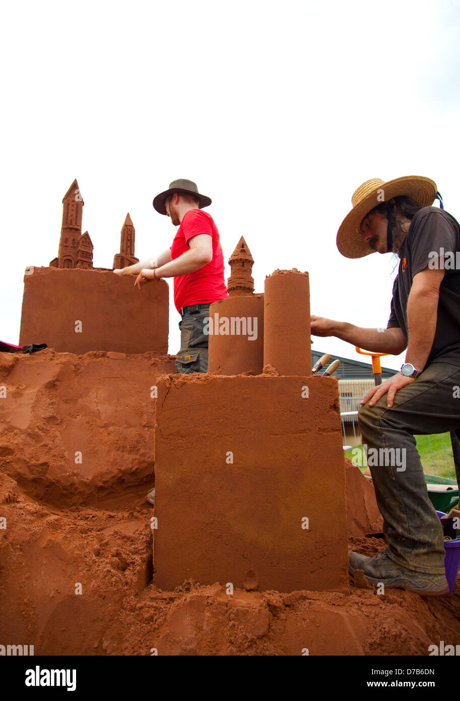 Sand artists Sand In Your Eye creating a sculpture of a castle on Rhyl ...