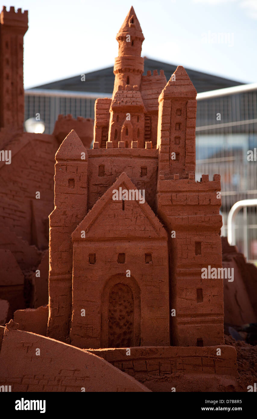 Sand artists Sand In Your Eye creating a sculpture of a castle on Rhyl ...