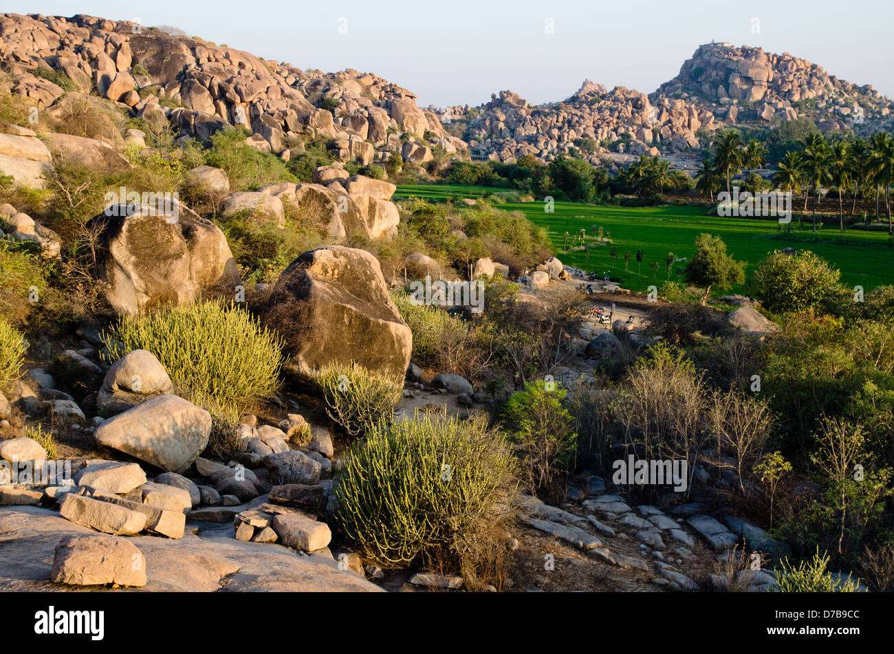 Exotic lush landscape with boulders and grassland, Hampi, Karnataka ...