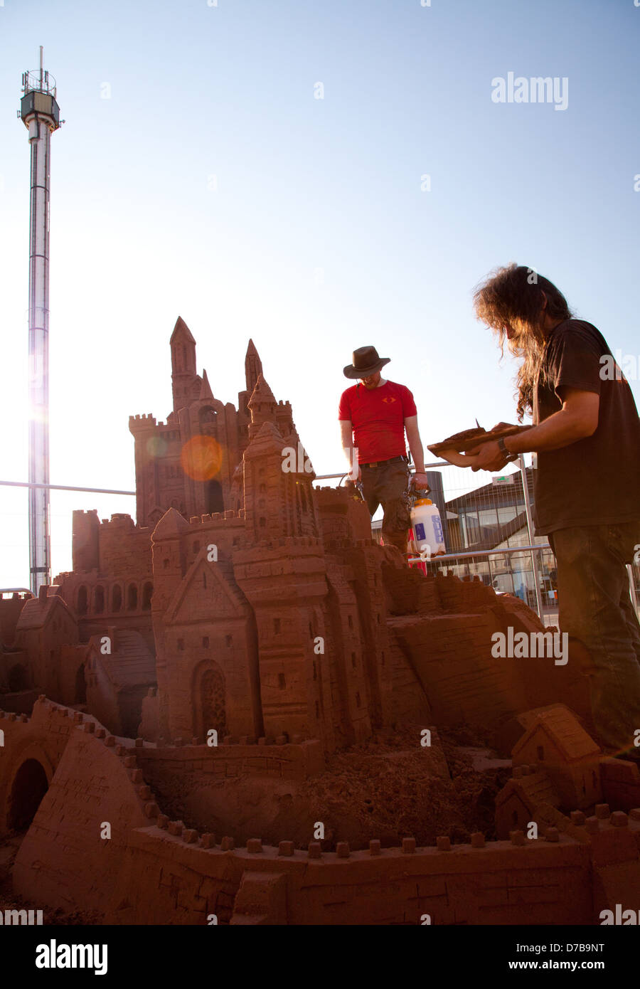 Sand artists Sand In Your Eye creating a sculpture of a castle on Rhyl ...