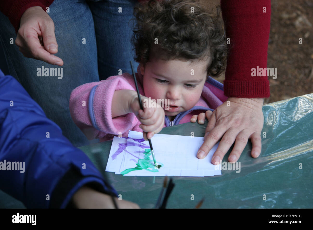 young child using a paintbrush to draw Stock Photo - Alamy