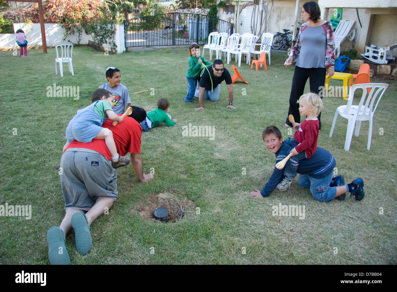 Parents and kids having fun in the courtyard Stock Photo - Alamy