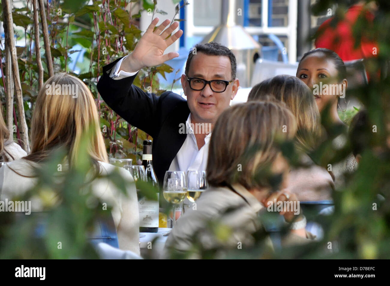 Tom Hanks eating with friends at an outside table at The River Cafe in ...