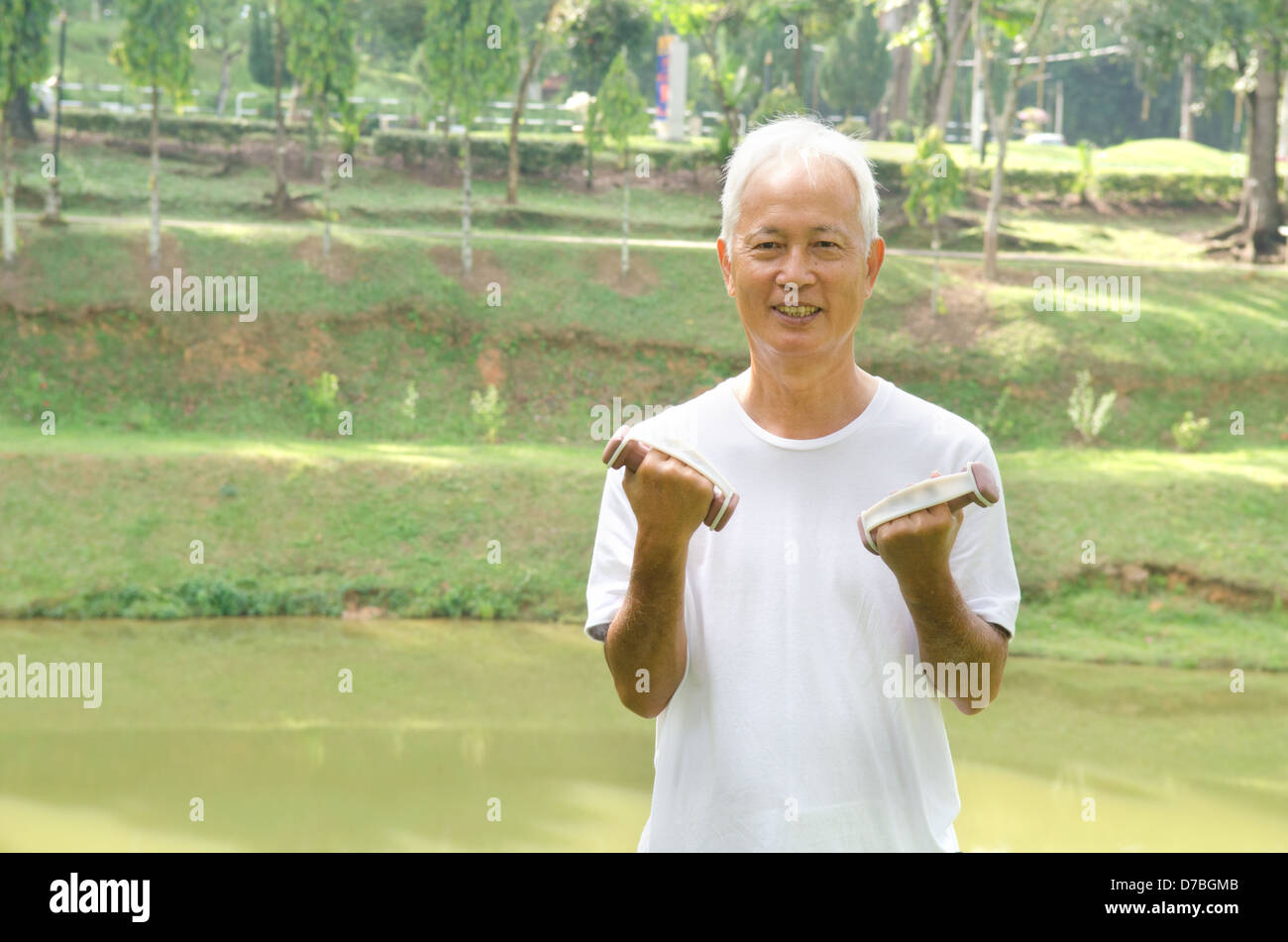 chinese Asian senior man healthy lifestyle working out on a park with a ...