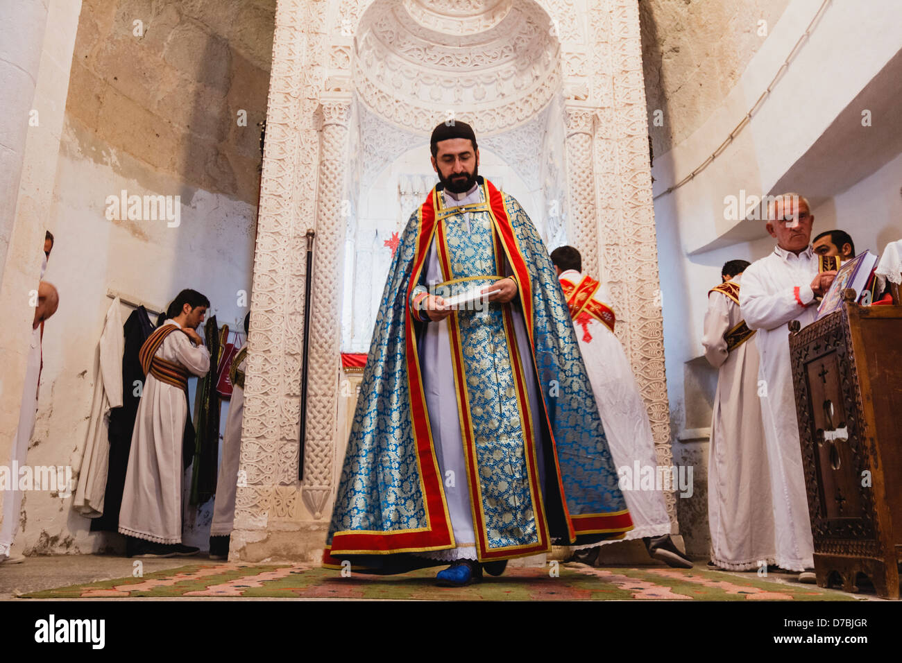 A Syriac Christian priest celebrating mass at an old church in Midyat ...